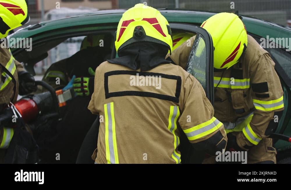 Firefighters using jaws of life to extricate trapped victim from the ...
