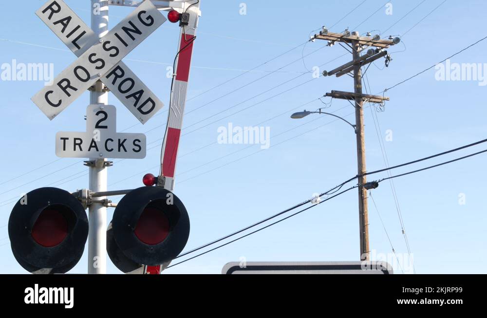 Level crossing warning signal in USA. Crossbuck notice and red traffic ...