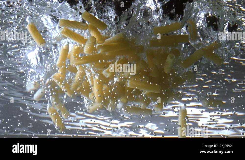 Pasta falling into boiling water Stock Video Footage - Alamy