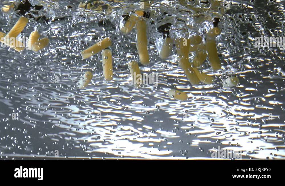 Pasta falling into boiling water Stock Video Footage - Alamy