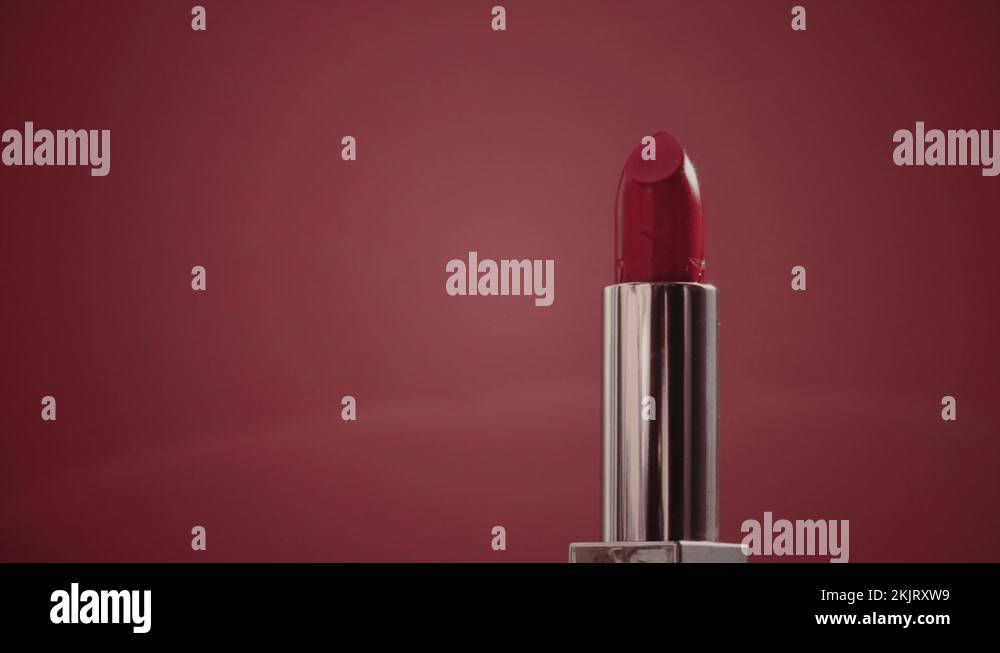 Vintage red lipstick in silver tube and shining light flares, luxury ...