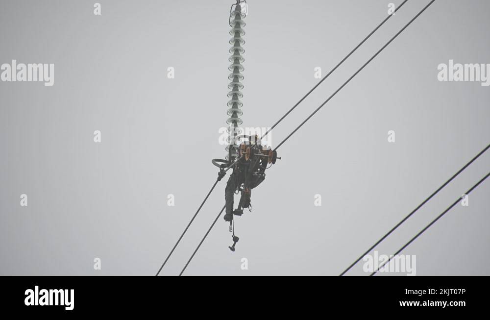 Skilled worker repairs electrical wiring on electric tower Stock Video ...