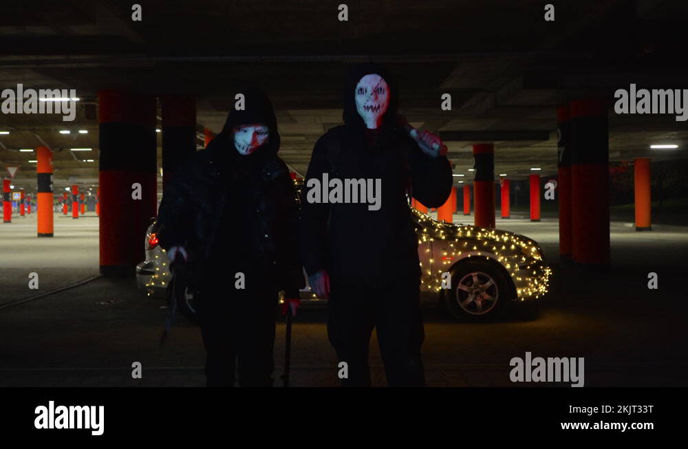 Man in scary white mask mask are holding a baseball bat and katana ...