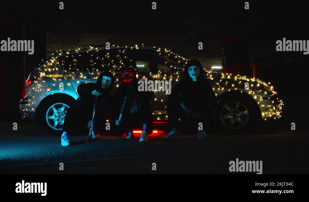 People with luminous purge masks are holding a baseball bat and katana ...