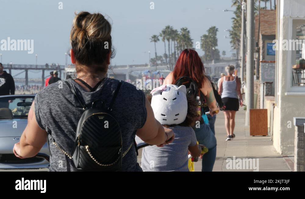 People walking, waterfront promenade beachfront boardwalk. Ocean beach ...