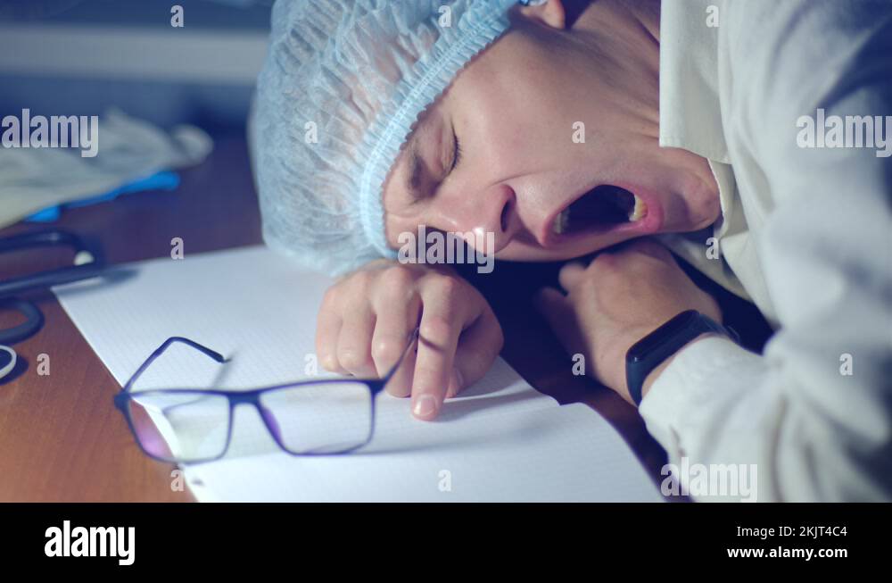 Tired and yawning doctor or scientist falling asleep at work place late ...
