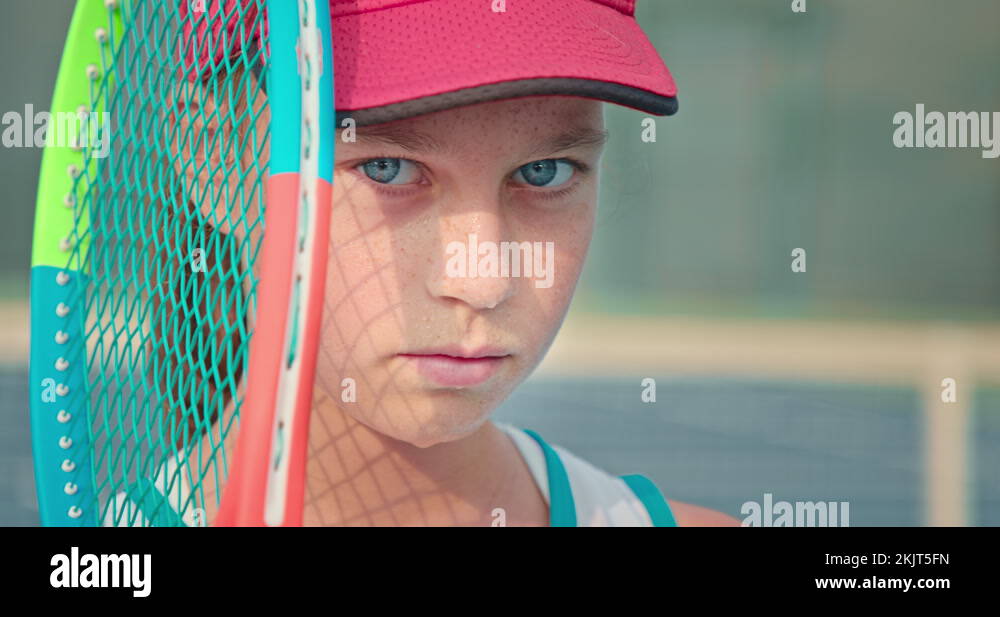 Cinematic shot of beautiful sweaty girl with big blue eyes and tennis ...
