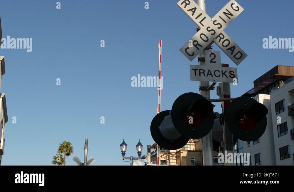 Level crossing warning signal in USA. Crossbuck notice and red traffic ...