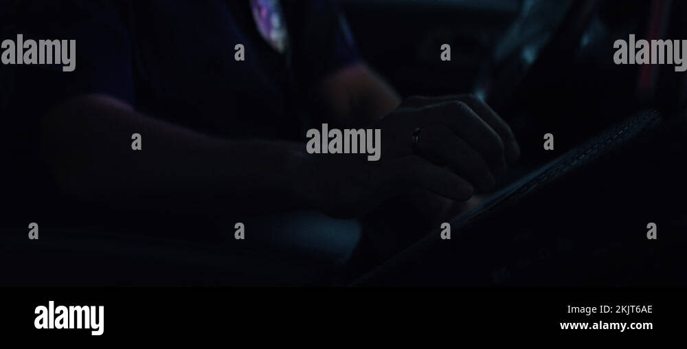 EXTREME CU Police officer checking info on a laptop inside a car Stock ...