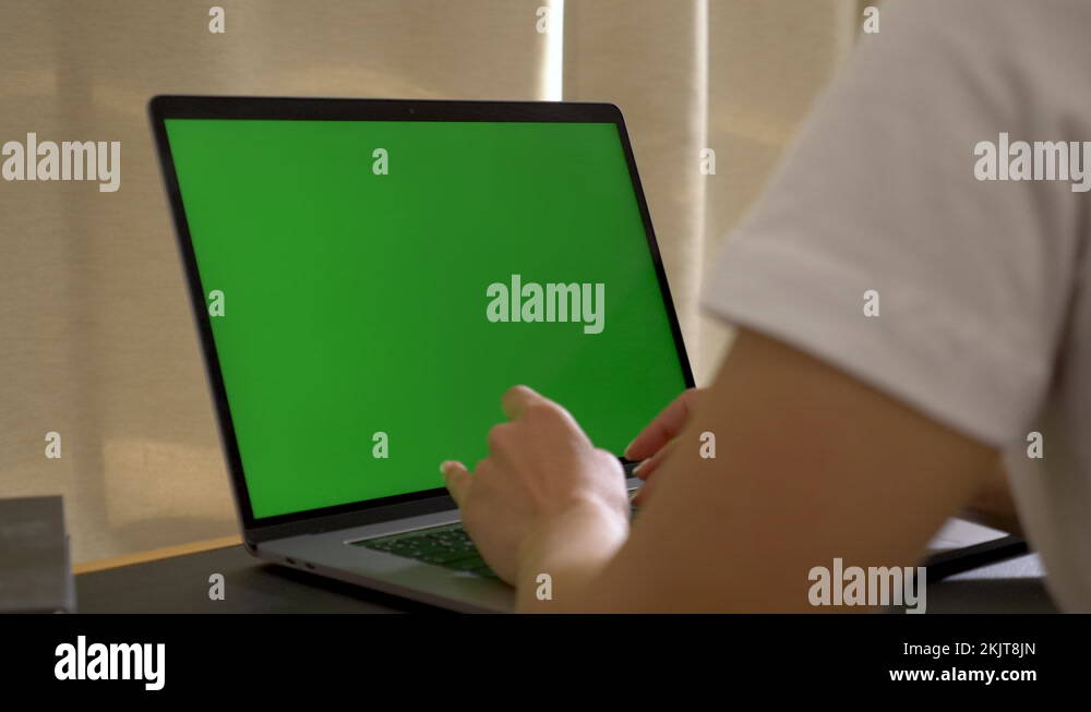 Over the shoulder shot of Asian woman looking at green screen Stock ...