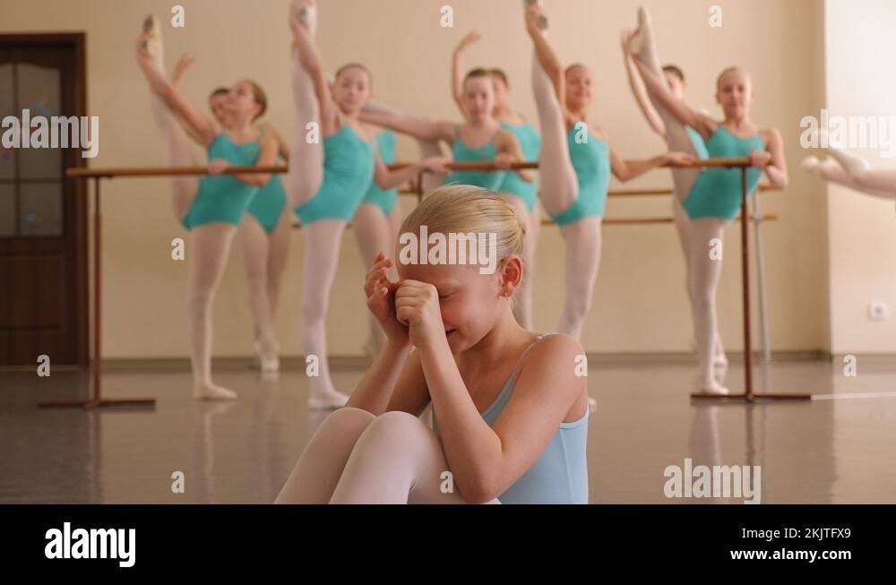 Close-up portrait of a little upset girl in a ballet Studio, she is ...