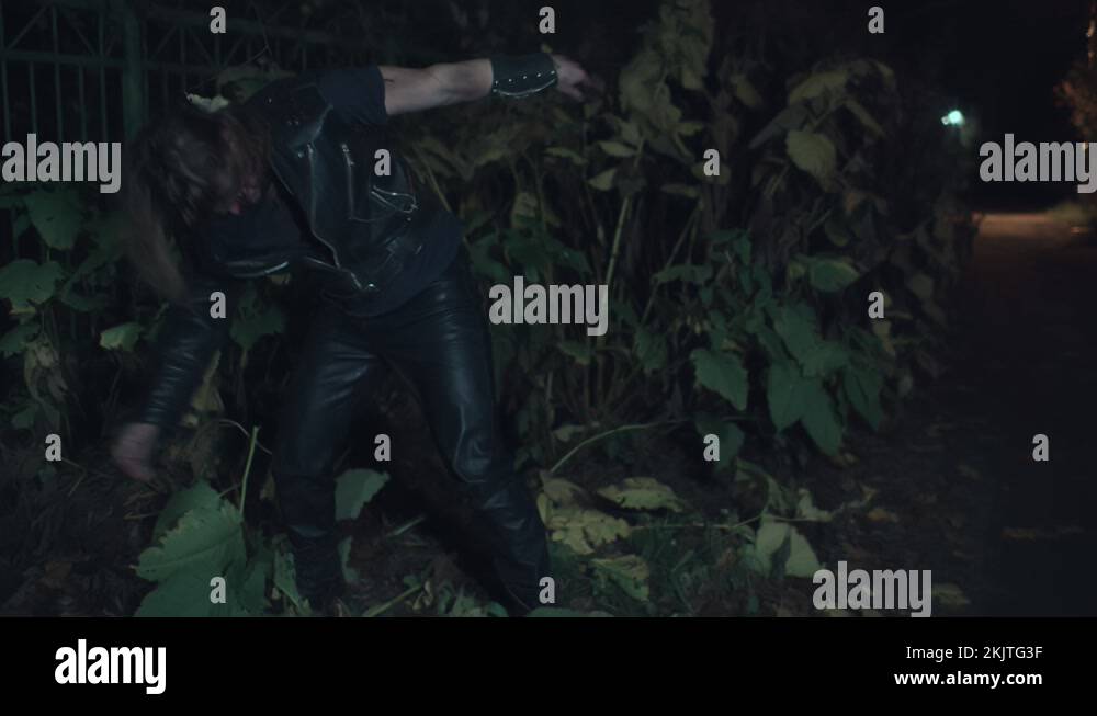 Scary zombie with bloody face standing up and walking outdoors Stock ...