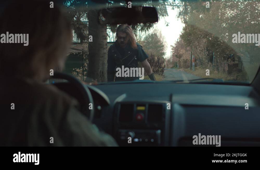 Zombie man attacking woman driving car on empty road Stock Video ...