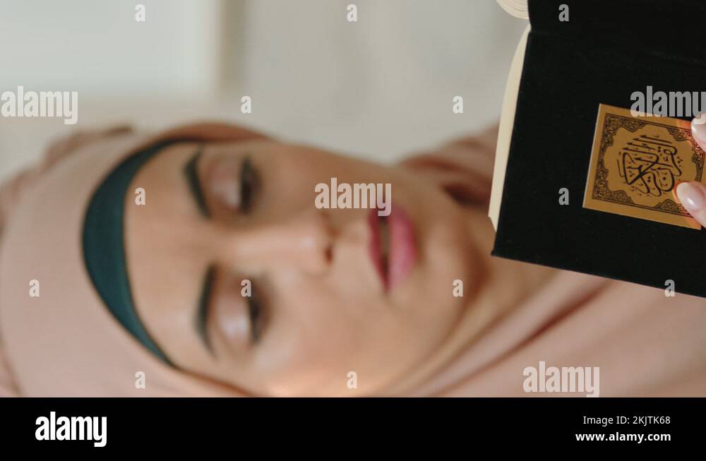 Young Muslim woman reading the Quran at home.Video for the vertical ...