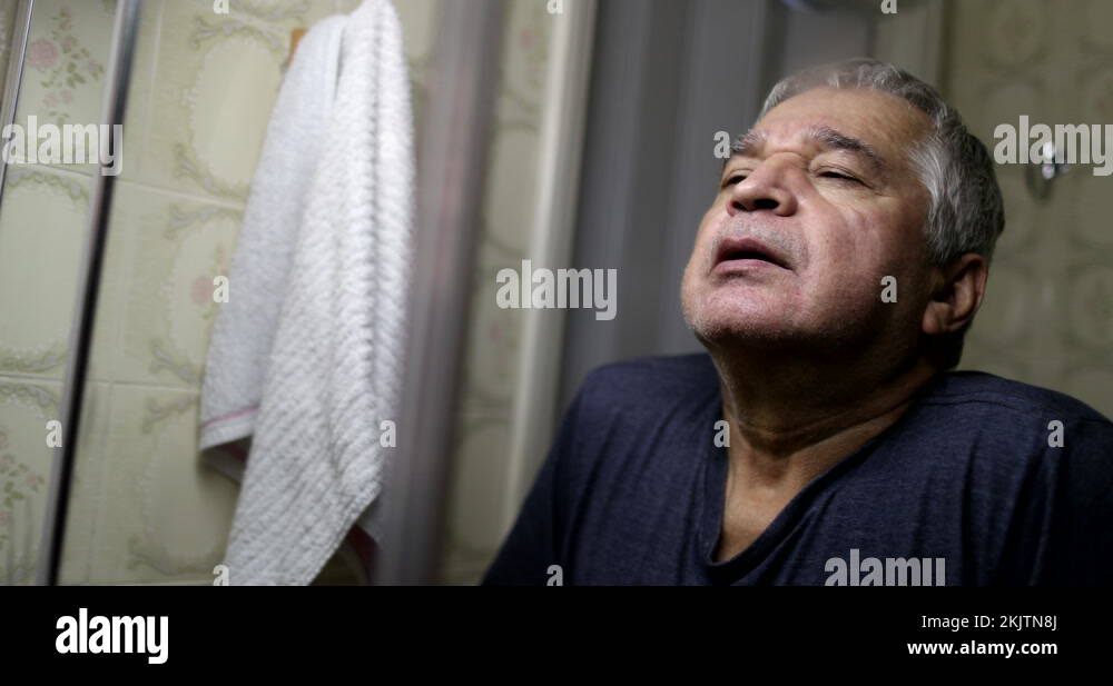 Old man shaking fear from face in front of bathroom mirror Stock Video ...