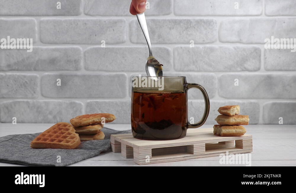 cinemagraph of stiring tea rotation, to brew a cup of herbal tea with a ...