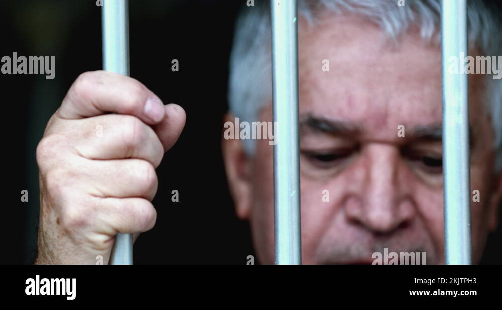 Prisoner locked behind metal bars. Old man trapped Stock Video Footage ...