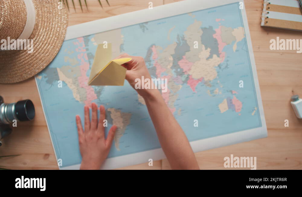 Flying Paper Airplane Above World Map Stock Video Footage - Alamy
