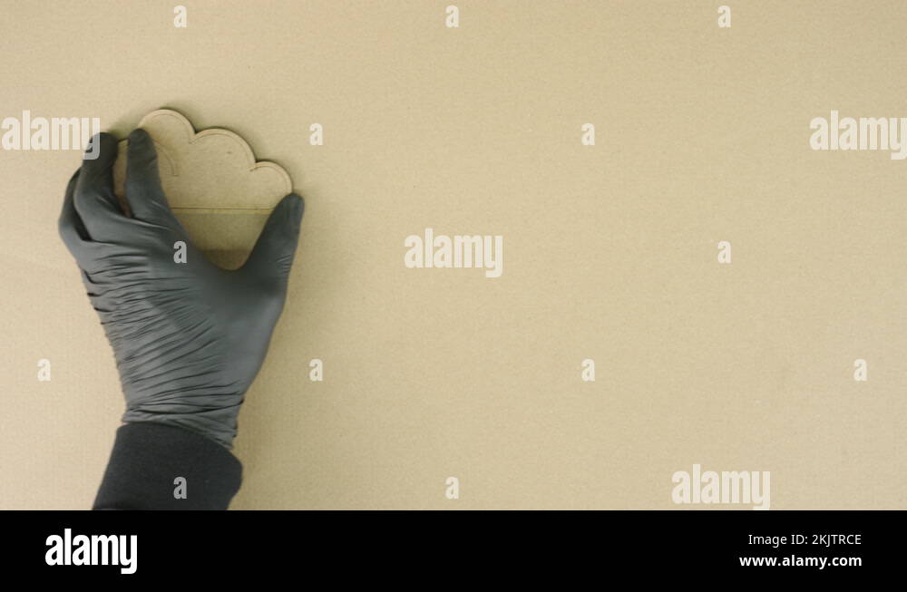 Placing cloud icons made of recycled cardboard on the table ...