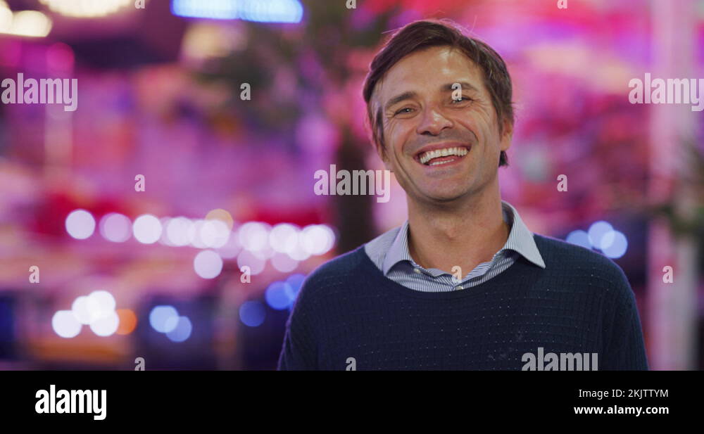 Happy father smiling in camera while having fun with his family at luna ...