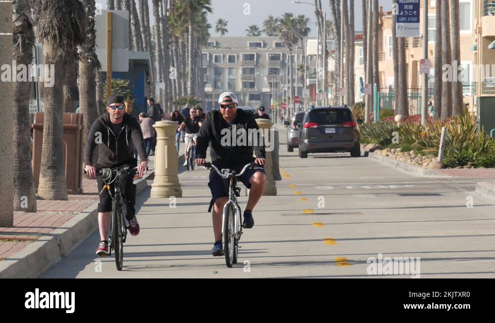 People walking, waterfront promenade beachfront boardwalk. Ocean beach ...