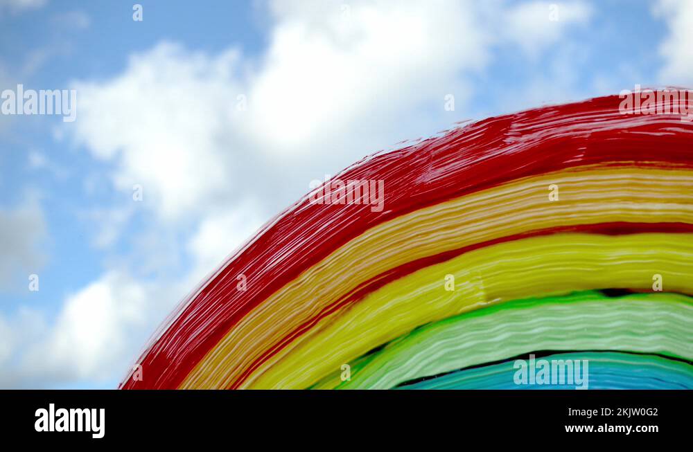 Colorful rainbow on window with blue sky background. Stay at home ...