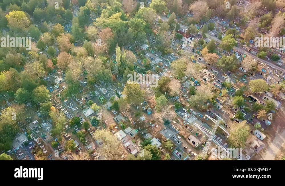 flying over cemetery. some graves are well-kept, while others are old ...