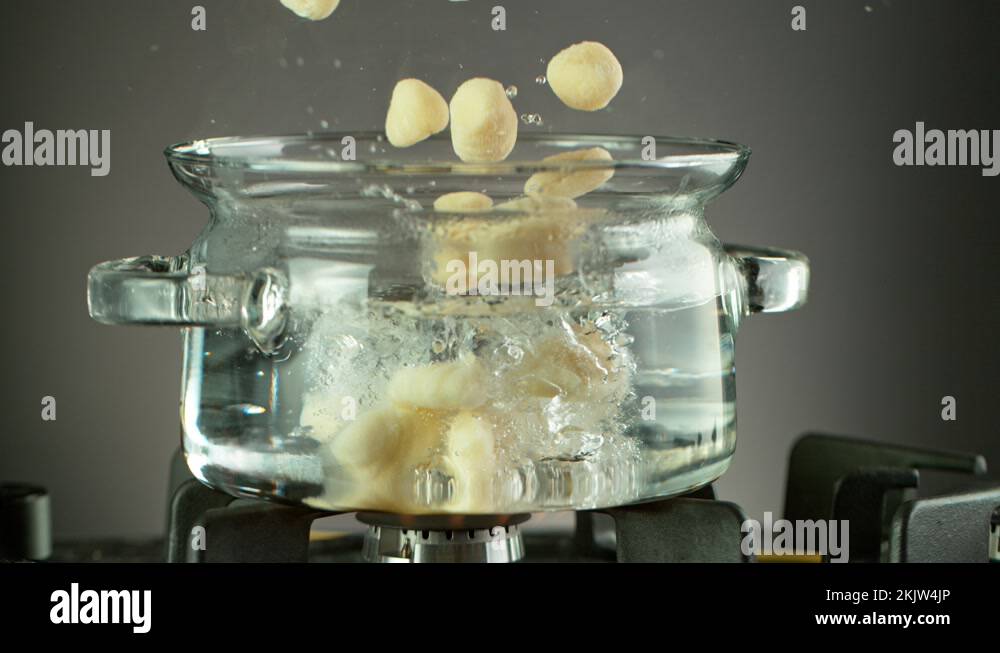 Super Slow Motion Shot of Fresh Gnocchi Falling into Boiling Salted ...