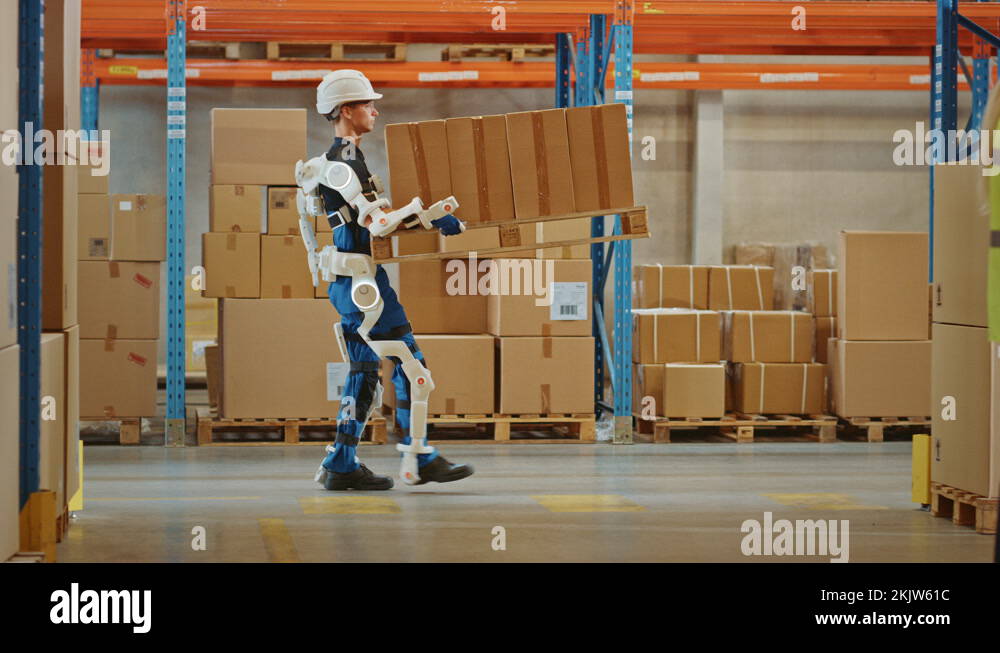 Futuristic Modern Warehouse Worker with Exoskeleton Suit Moves Stock ...