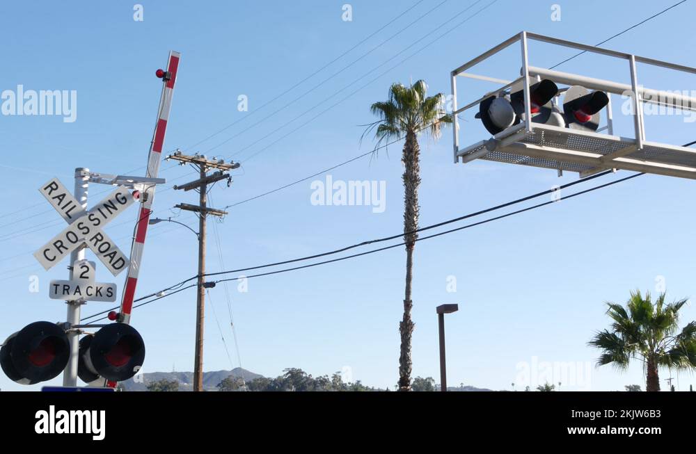 Level crossing warning signal in USA. Crossbuck notice and red traffic ...