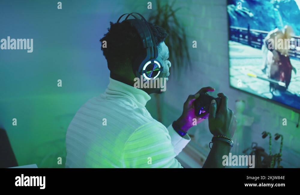 African black man gamer playing video games using joystic controller ...