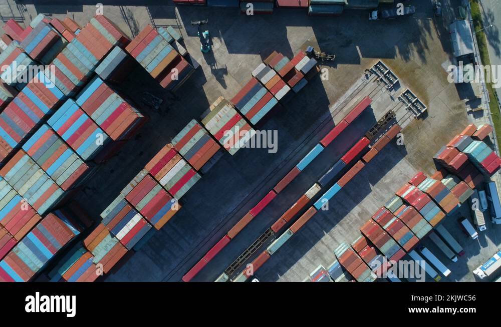Overhead drone footage of shipping containers with transport network ...