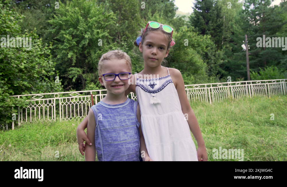 Two little kids hugging and waving. Young cute careless children ...
