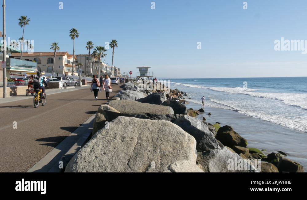 People walking, waterfront promenade beachfront boardwalk. Ocean beach ...
