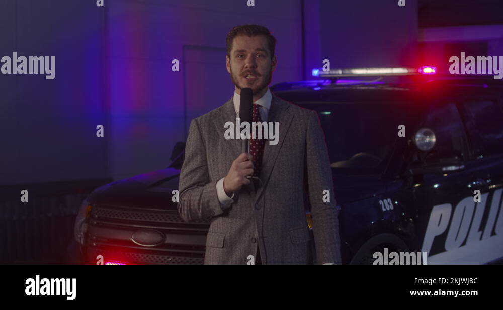 FIXED Reporter talking into camera on a crime scene, police car lights ...