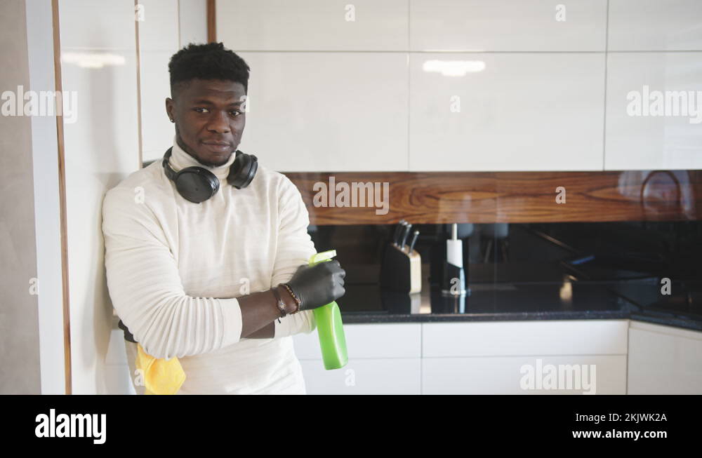 Young black man admiring cleanlines of the kitchen after work Stock ...