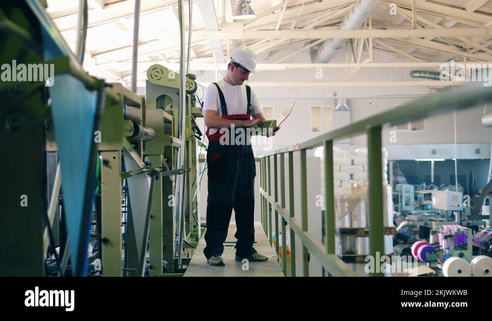 Factory worker monitoring production process Stock Videos & Footage ...