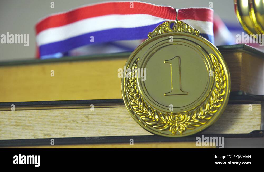 golden trophy and first medal on stack of books Stock Video Footage - Alamy