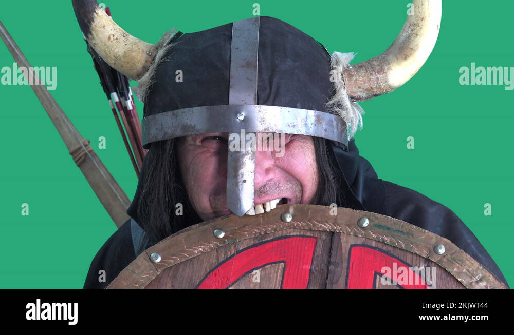 Aggressive viking warrior scares enemies by biting with crooked teeth ...