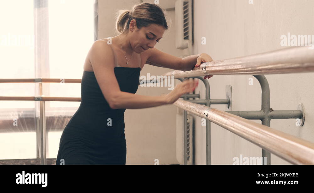 Ballerina rehearsing with raised leg and arm at dance hall Stock Video ...
