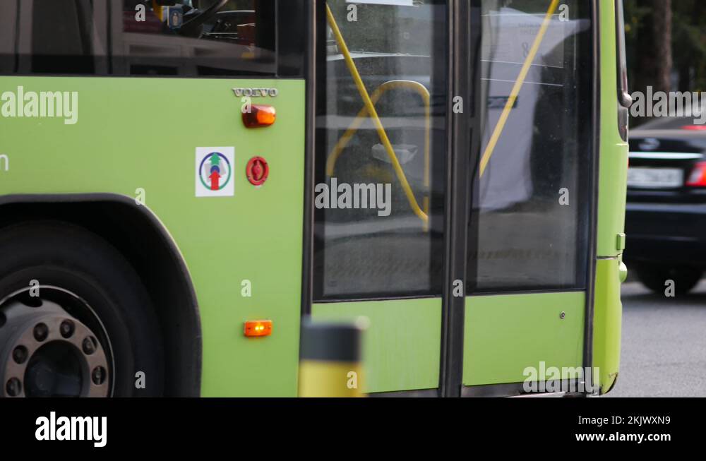 The bus departs from a public transport stop. Passenger Transportation ...