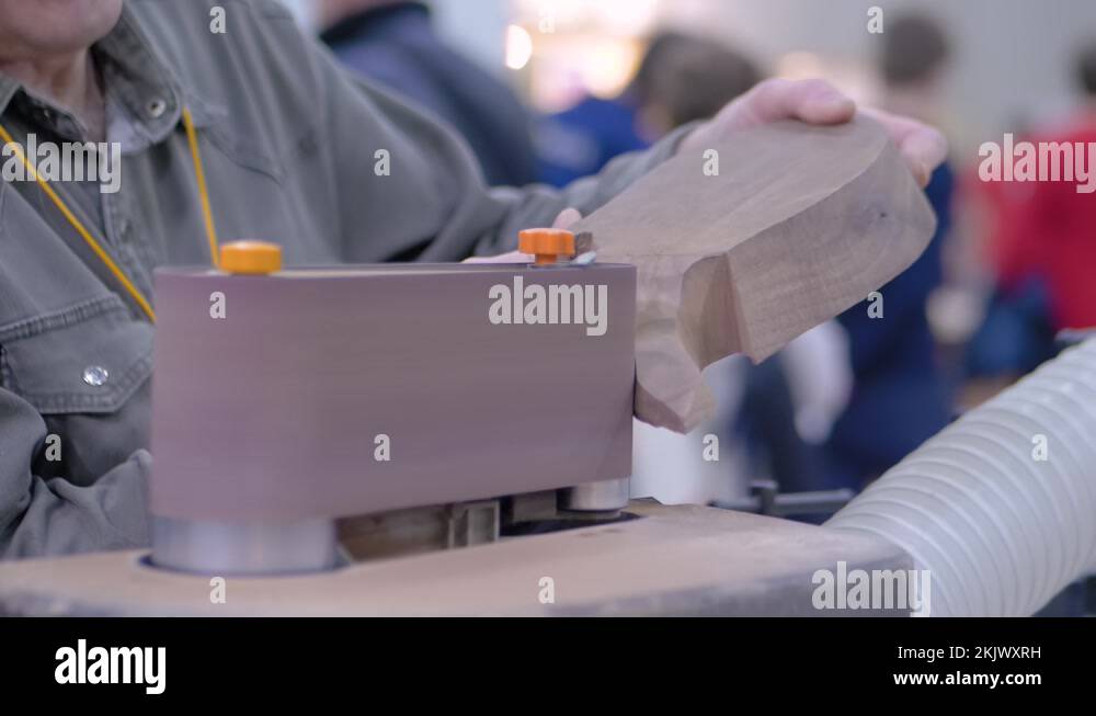 Man carpenter using belt sander machine, polishing wood product: slow ...