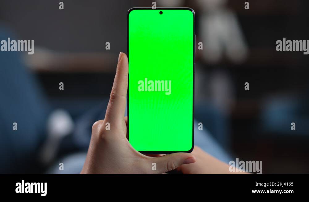 Closeup of Woman`s Hand is Holding Chroma Key Green Screen vertical ...