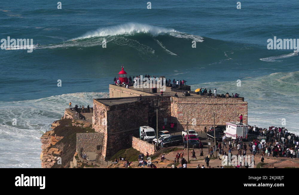 Nazare, Portugal, Surfer Riding Giant Wave Near the Fort of Nazare ...