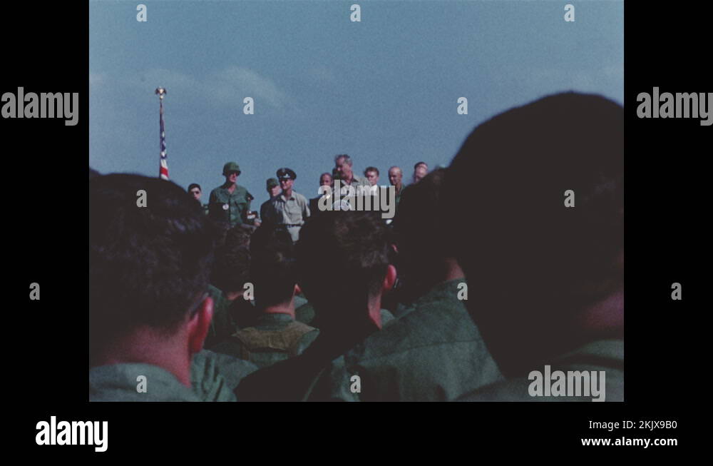 1960s Vietnam: View from crowd of soldiers, Lyndon Johnson speaking on ...