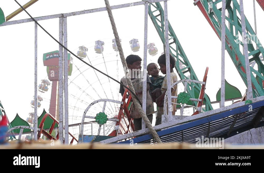 Kids playing on carnival ride, Kids on the swing ride, Mumbai, India ...