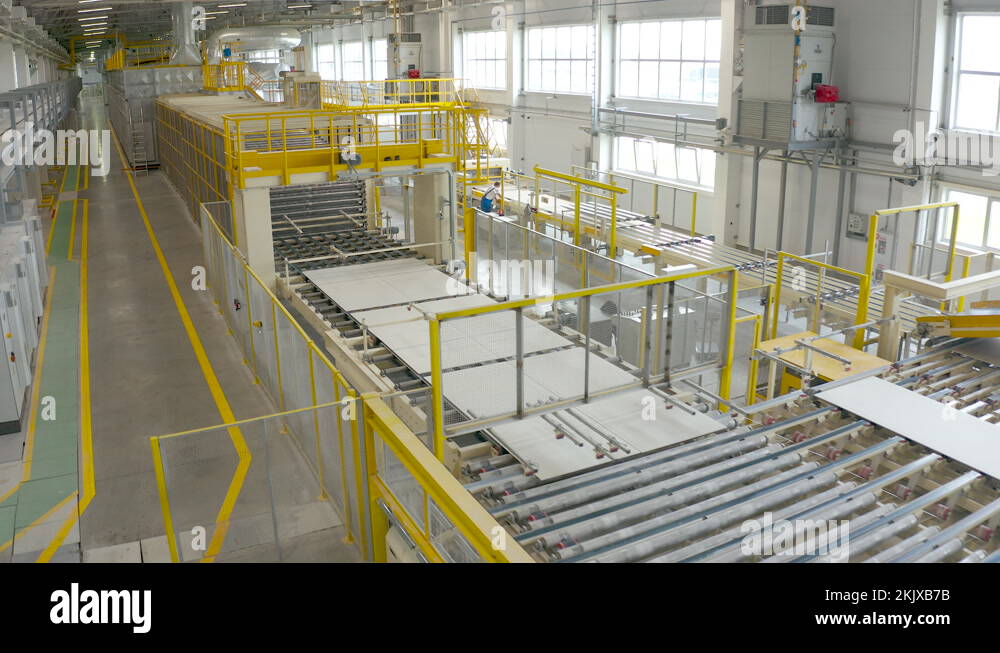 Manufacturing drywall or gypsum board by conveyor on factory ...