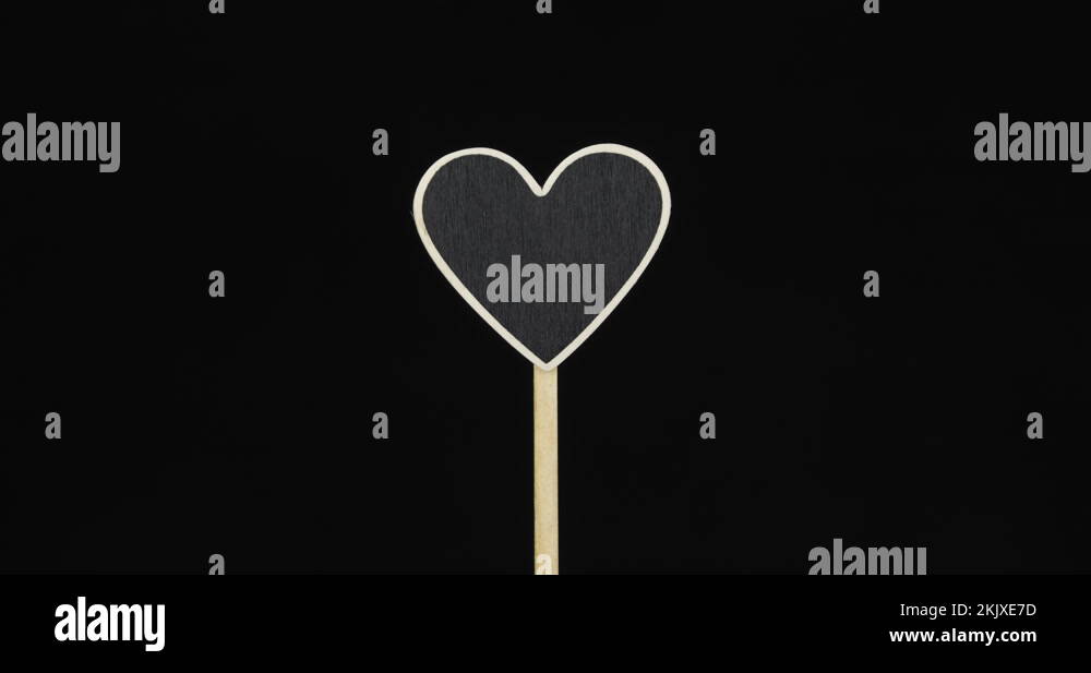 Zoom of blank sign in the shape of a heart. Black background Stock ...