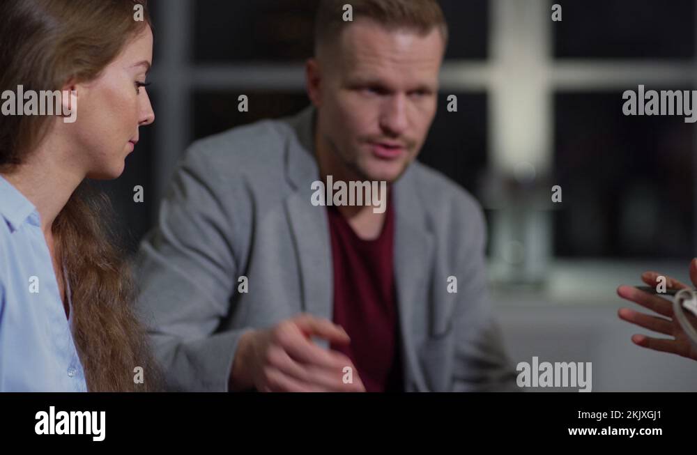 Furious woman fighting with husband during talk with family ...