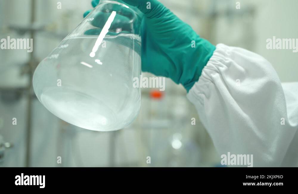 scientist hand shaking Erlenmeyer flask in laboratory slow motion Stock ...